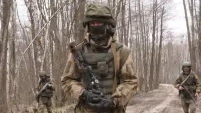 Belarus KGB soldiers in full camouflage gear patrolling a forest in 2025, symbolizing state security forces enforcing Lukashenko’s control.